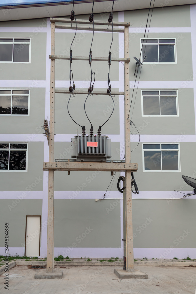 AC high-voltage power transformers and high voltage cables on the pole ...