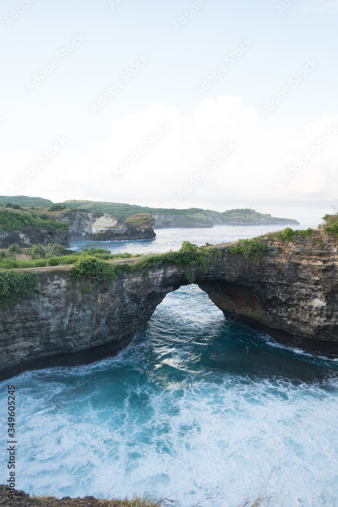 destroyed rocks and a Bay with an arch on an island in the Indian ocean ...