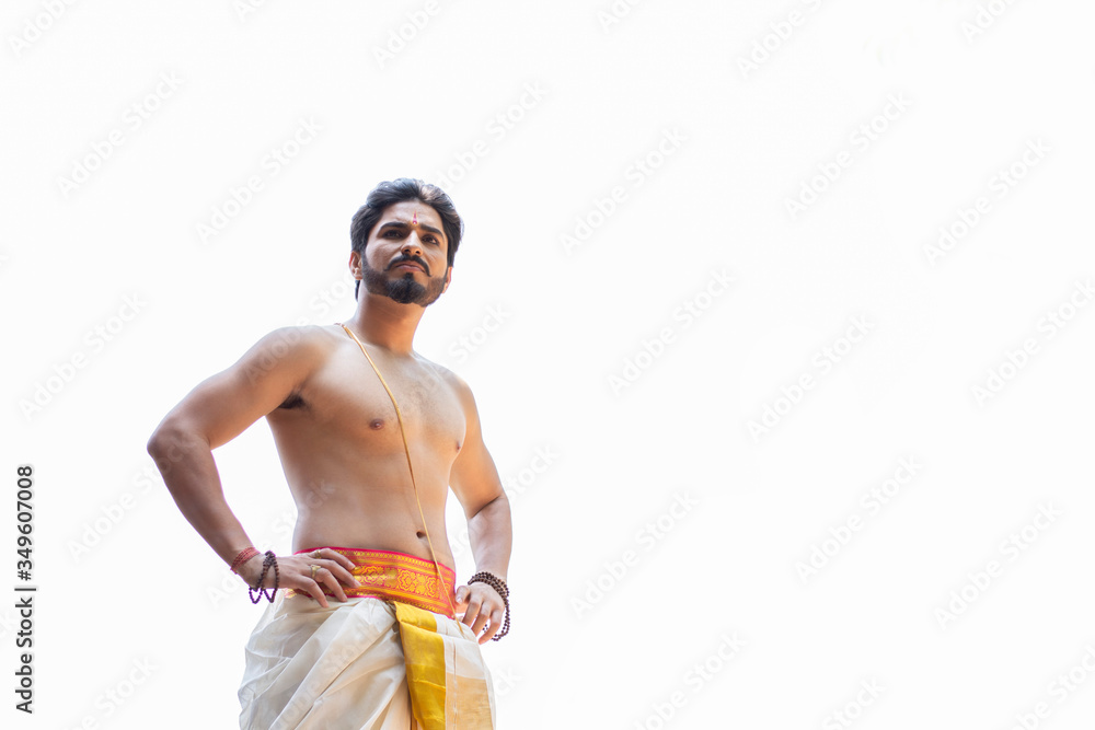 Low angle portrait of an Indian pujari/ worshiper in bare body Indian ...