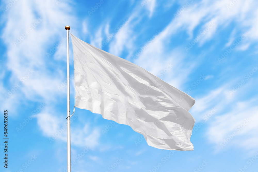 Blank white flag on pole waving in the wind in the background of cloudy ...