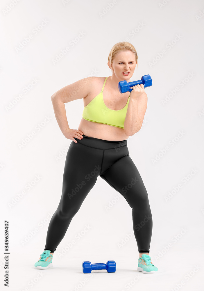 Woman with excess weight training on white background Stock Photo ...