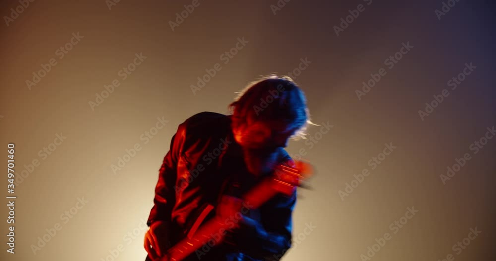 An amazing rock music player performing. Grunge musician is playing ...