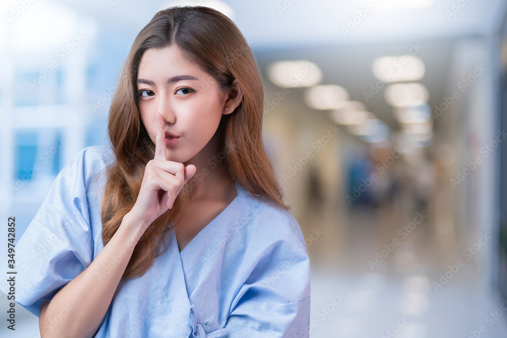 Beautiful Asian female patient hospital uniform looking at camera ...