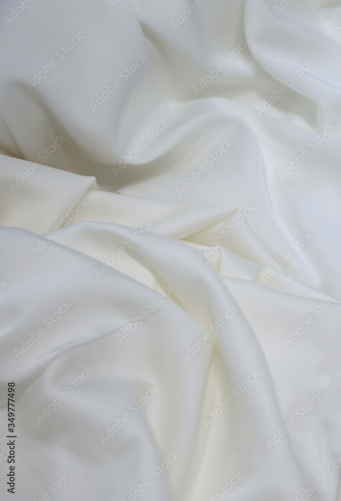 Close up picture of silk fabric in ivory shade with wavy holds on ...