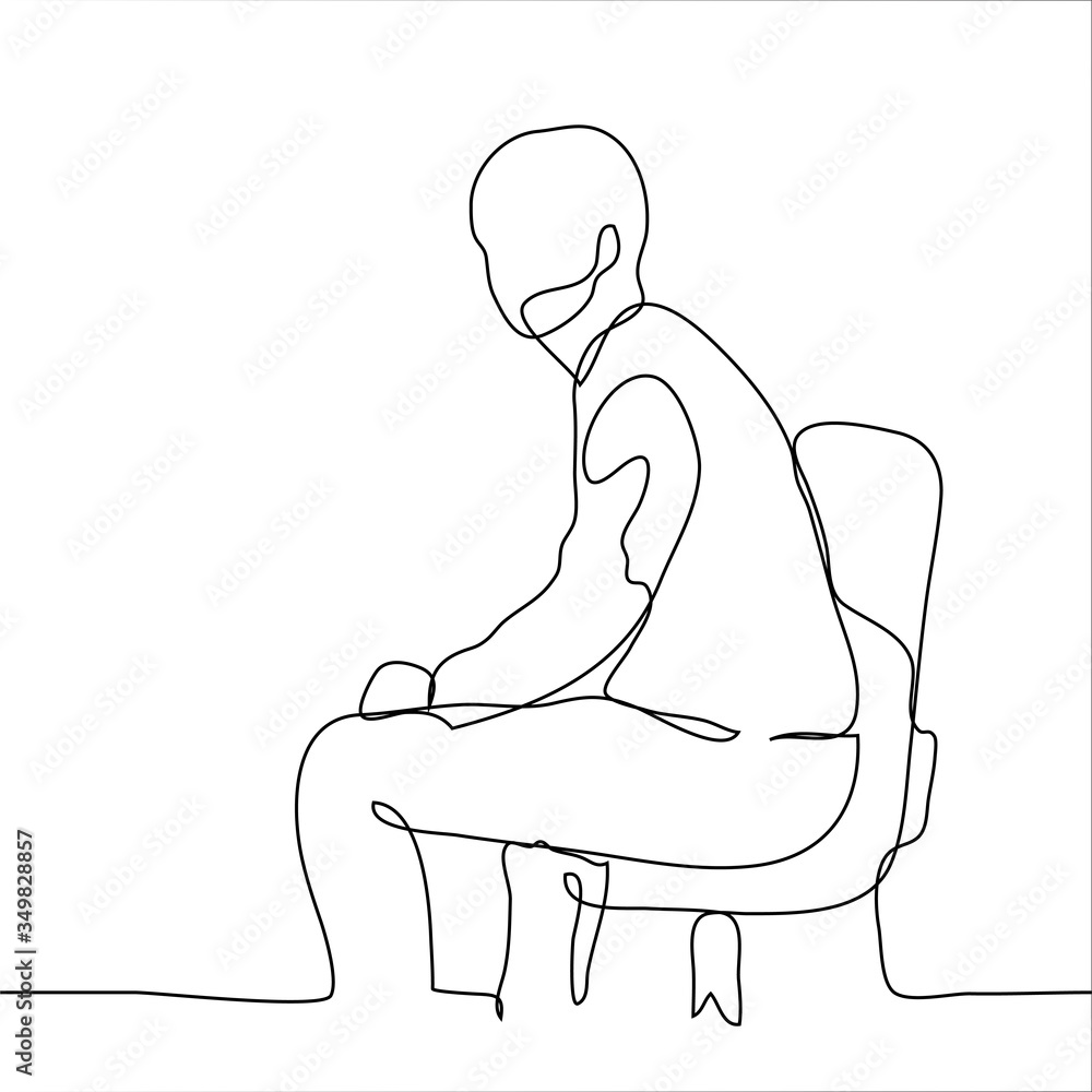 man sits on a chair, turning his head to the side, he looks somewhere ...