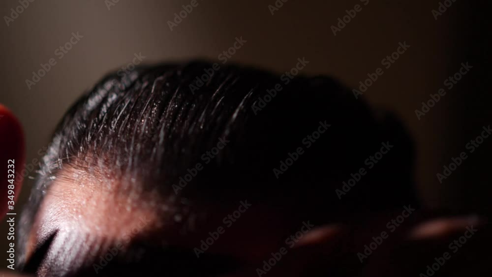 Man Combing His Hair With a Comb Brush in the Slick Back Style in a ...