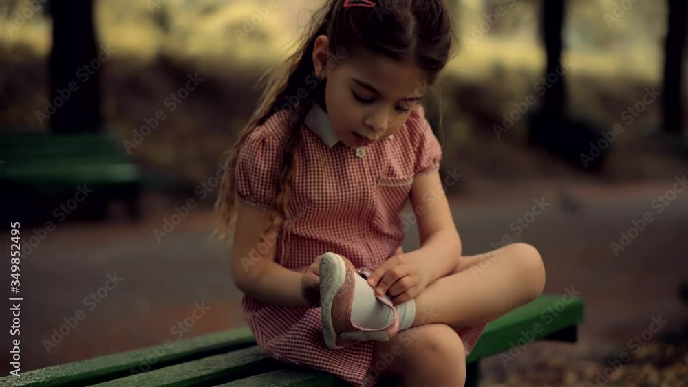 Adorable Little Kid Sitting And Tying Sneakers Shoes.Happy Cheerful ...