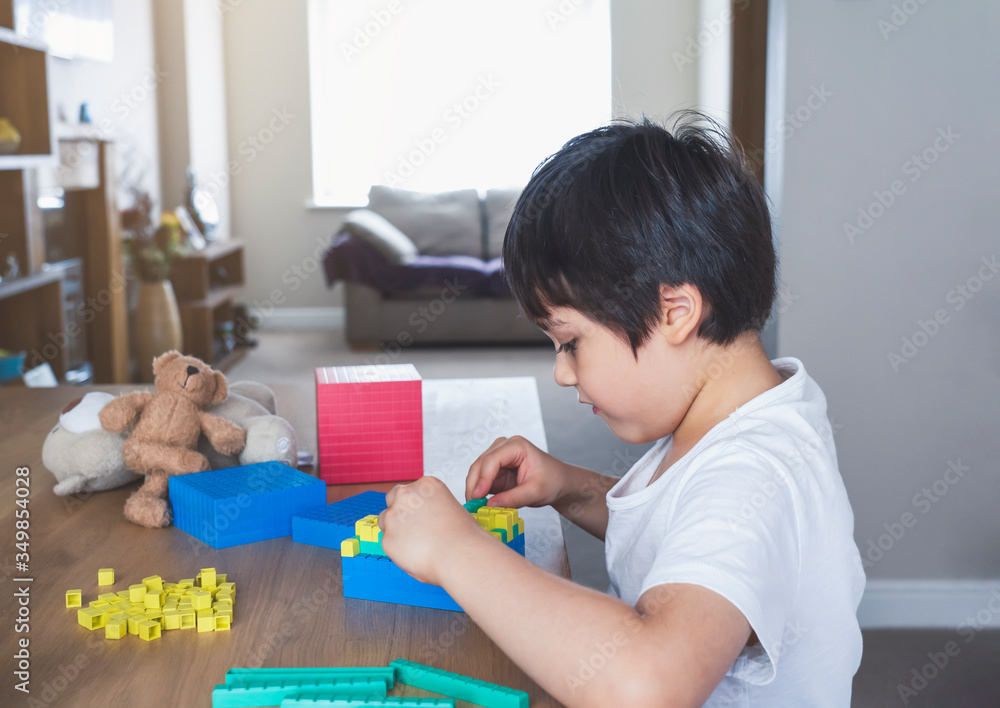 School kid using plastic block counting number, Child boy studying math ...