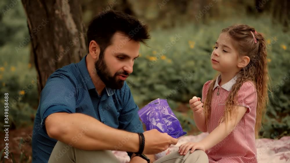 Daughter With Cheerful Father Eat Candy.Happy Beautiful Family Relaxing ...