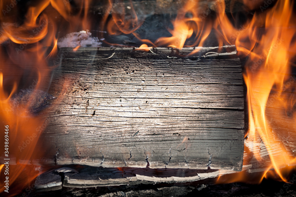 Burning black horizontal board with open red fire flame. Grey burned ...