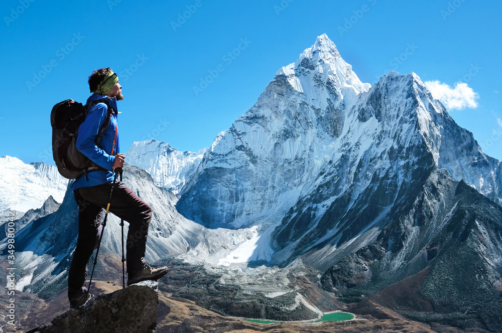 Climber reaches the summit of mountain peak. Success, freedom and ...
