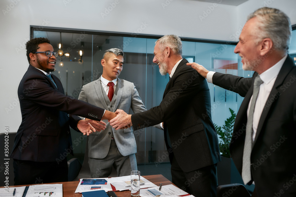 Contract on good conditions.Two happy businessmen in classic wear ...