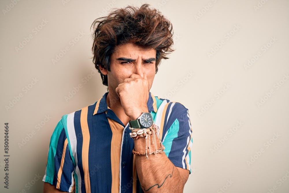 Young man on vacation wearing summer colorful shirt standing over ...