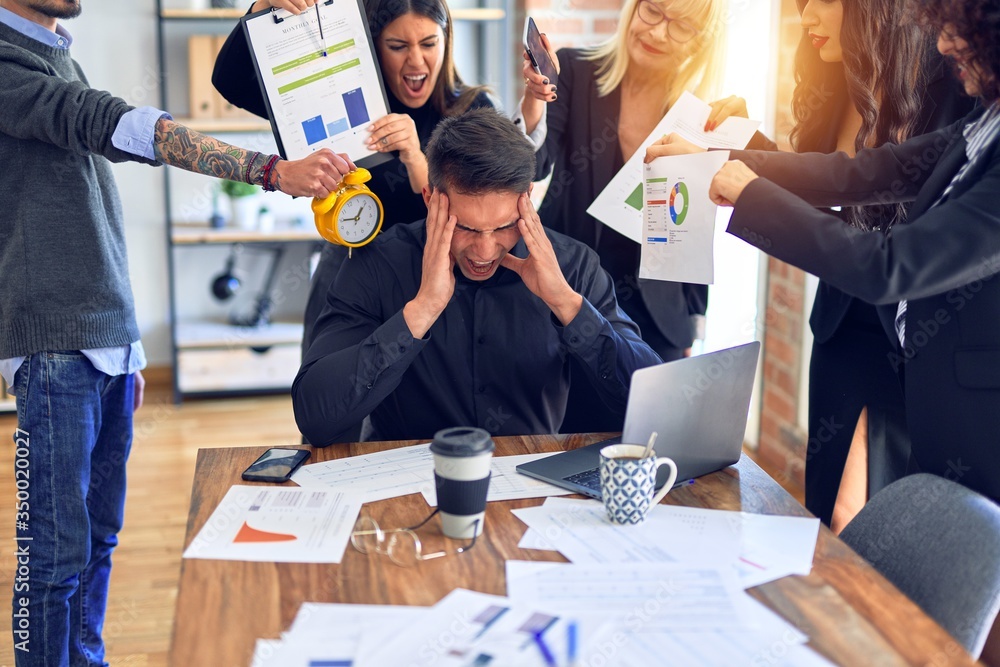 Group of business workers working together. Partners stressing one of ...