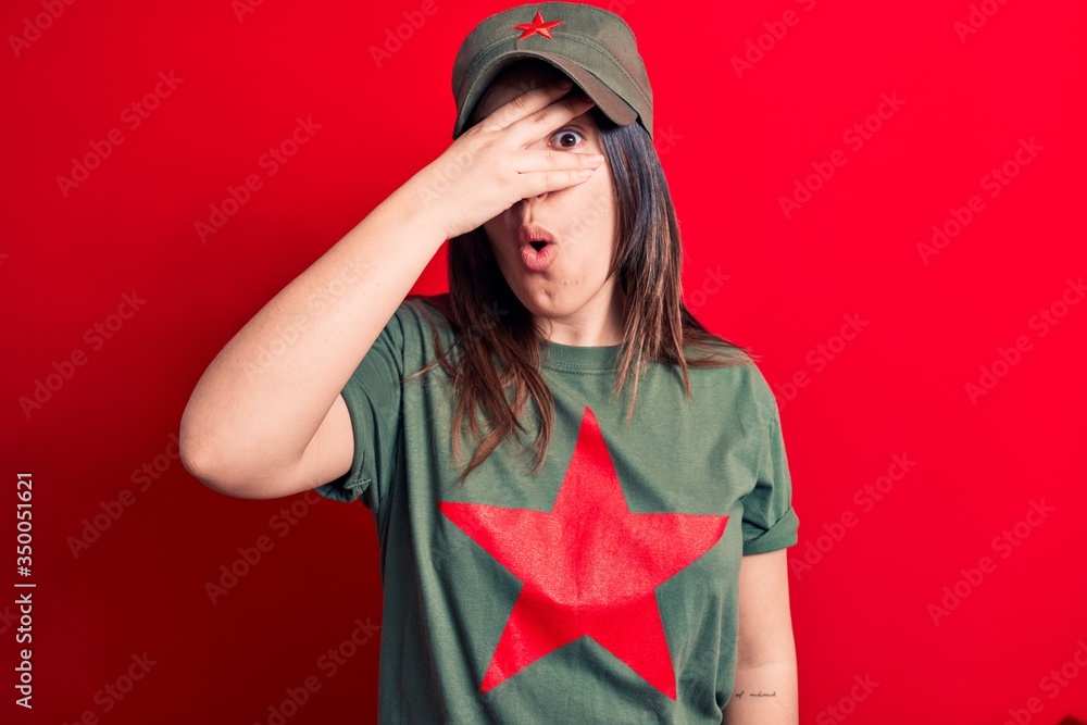 Young beautiful brunette woman wearing cap and t-shirt with red star ...
