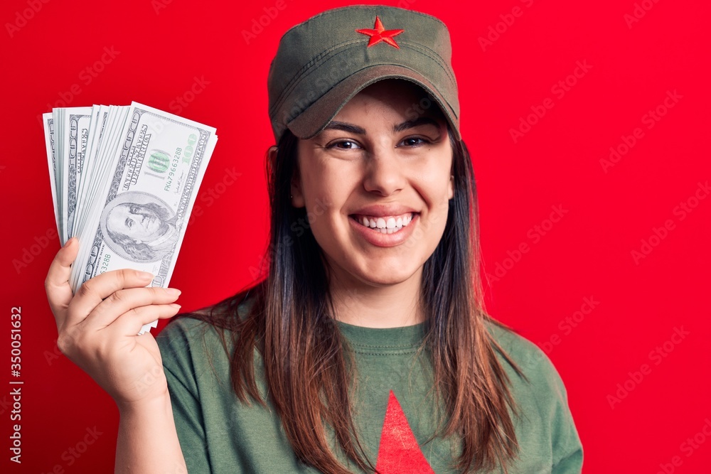 Woman wearing t-shirt with red star communist symbol holding bunch of ...