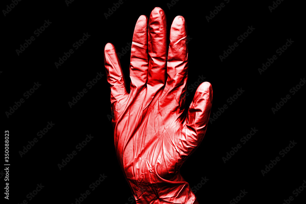 Human hand in red rubber medical glove on black background isolated ...