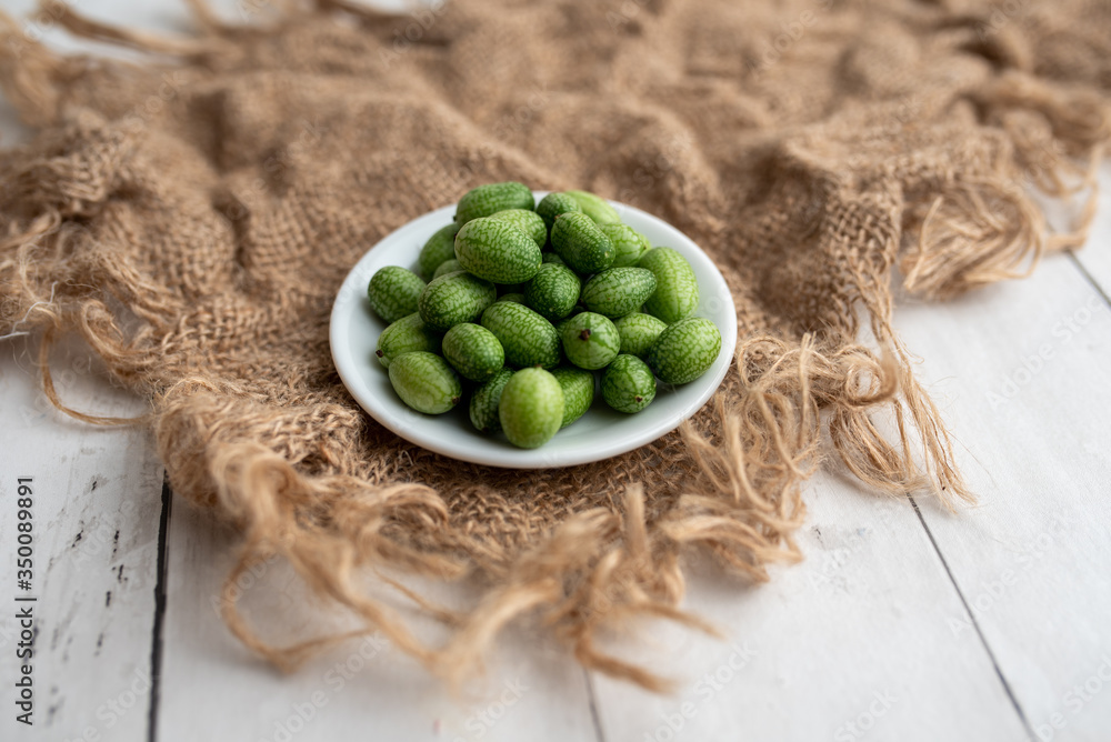 Freshly harvested cucamelons, Mexican sour gherkin pepquino or mouse ...