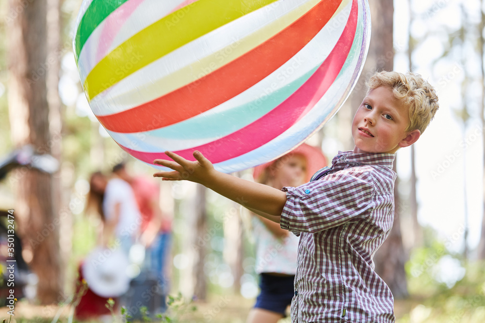 Boy plays with a big colorful ball Stock Photo | Adobe Stock