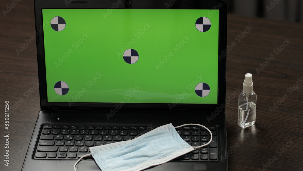 Medical mask, sanitizer. Laptop green screen, chroma key. Coronavirus ...