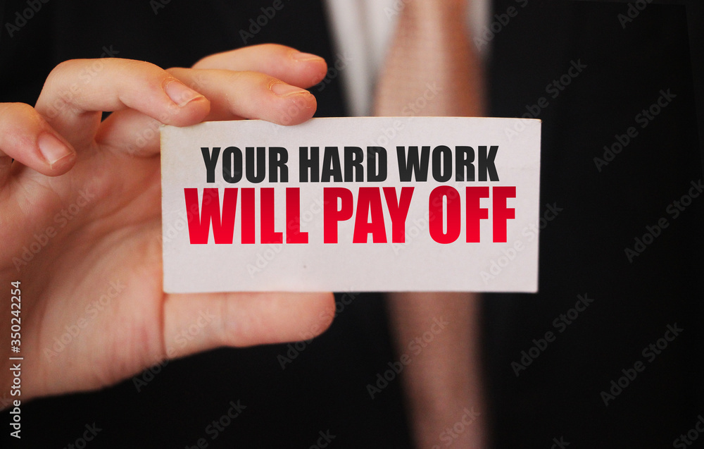 Your Hard Work Will Pay Off inspirational text on card in businessman ...