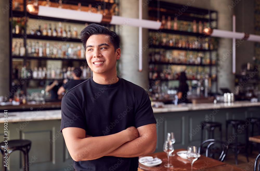 Portrait Of Male Waiter Standing In Bar Restaurant Before Service Stock ...