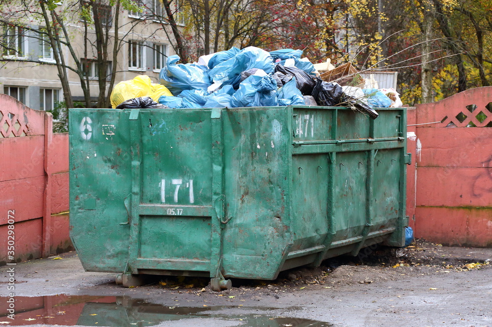 Big dumpster full of garbage Stock Photo | Adobe Stock