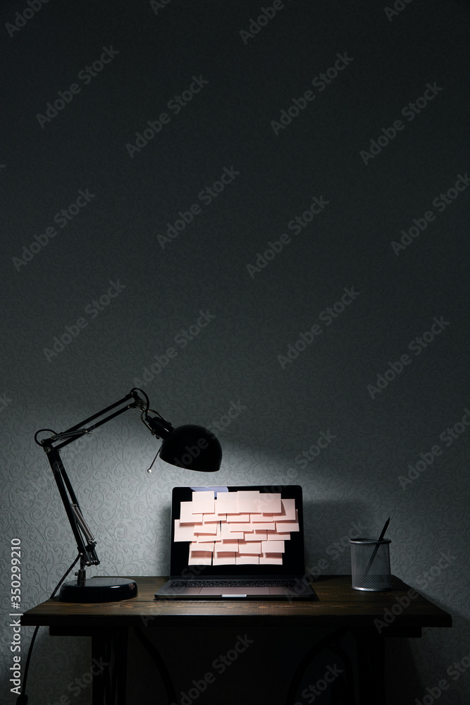 Image of laptop full of sticky notes reminders on screen. Late night ...