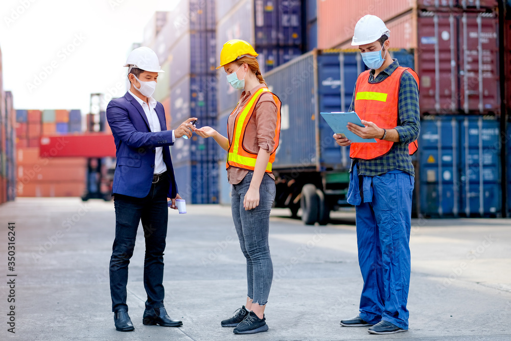 Manager put hands gel to technician or engineer worker while other ...