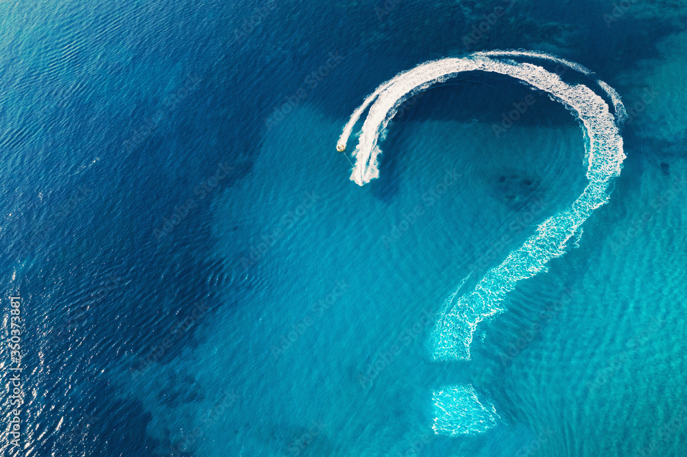 Question mark on tropical sea water surface as symbol of uncertainties ...