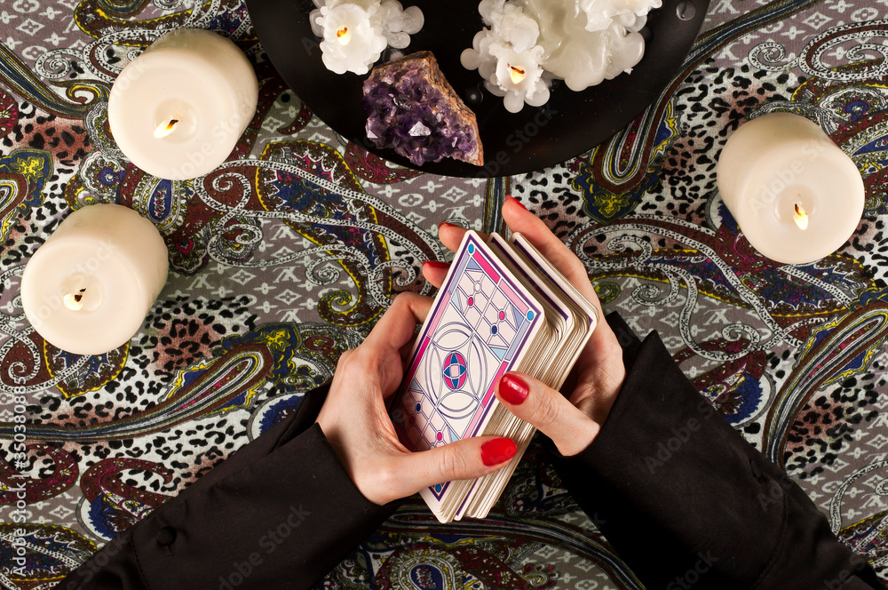 Fortune teller woman predicting future from cards on a table with ...
