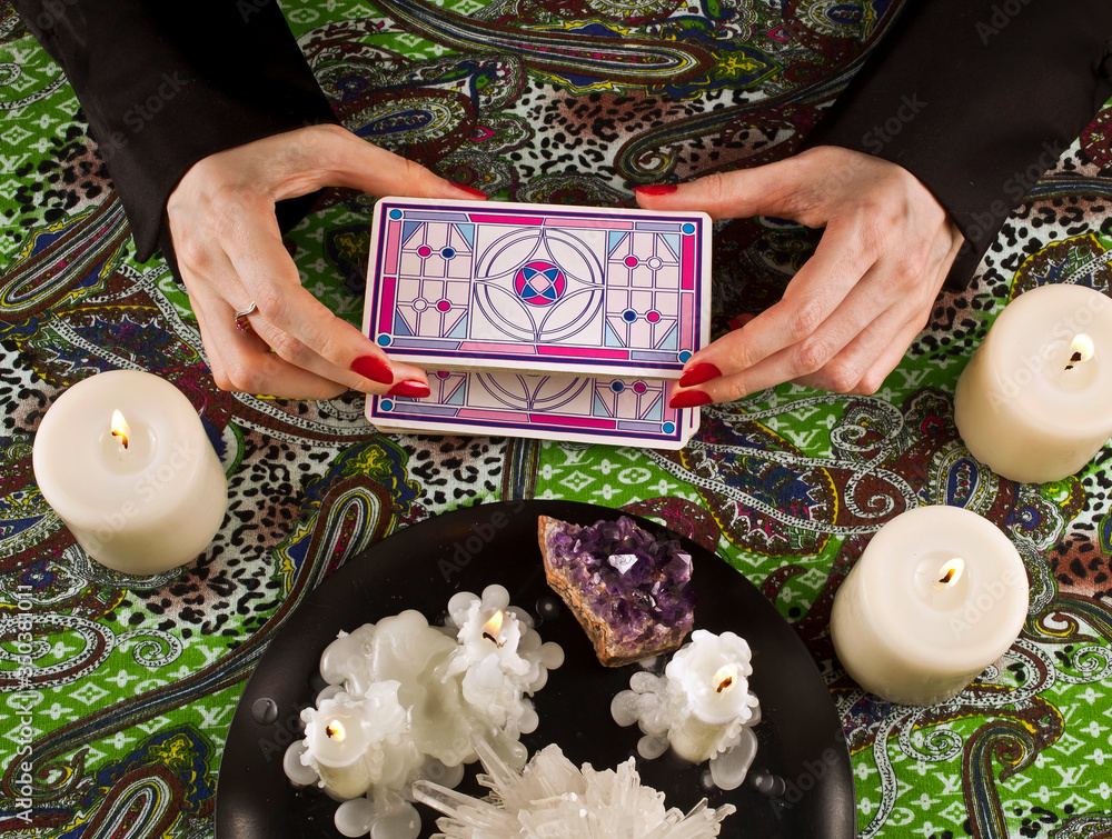 Fortune teller woman predicting future from cards on a table with ...