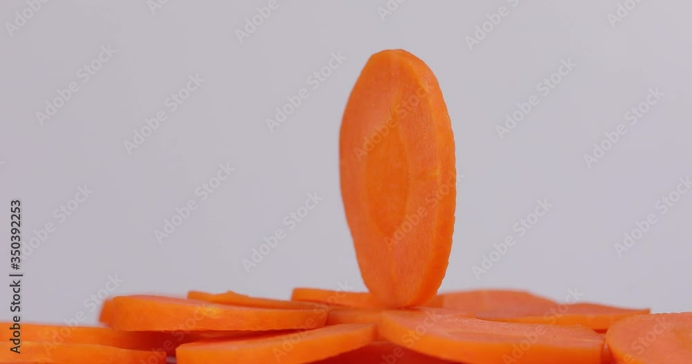 Carrots one piece spins on a white background and stands on pieces of ...