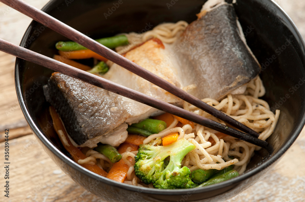 Asian noodles with fish fillet and vegetables Stock Photo | Adobe Stock
