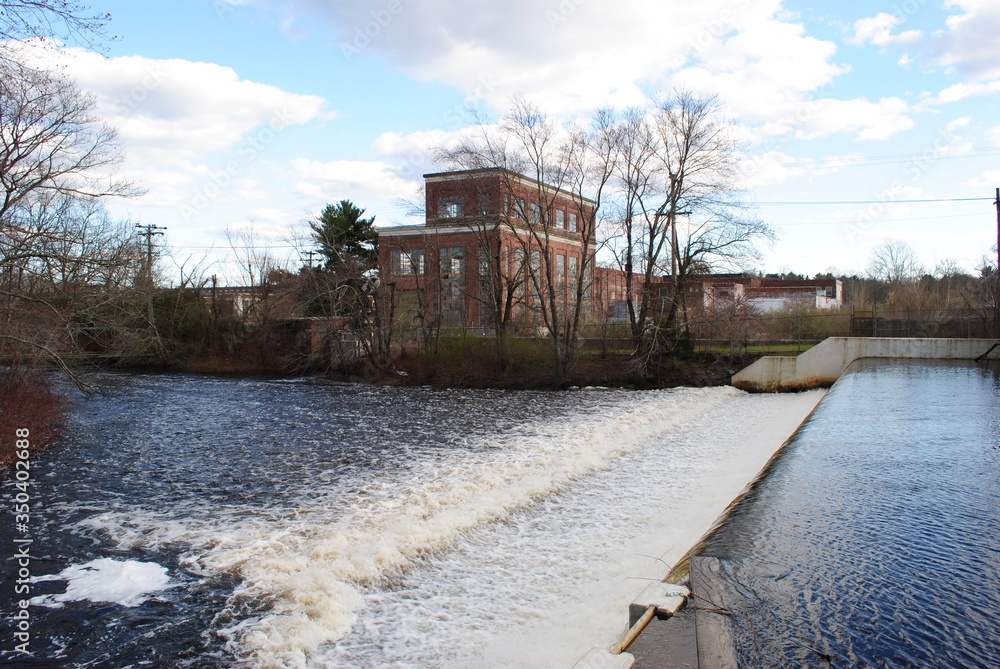 Abandoned old mill building circa early 1900s across from river and ...
