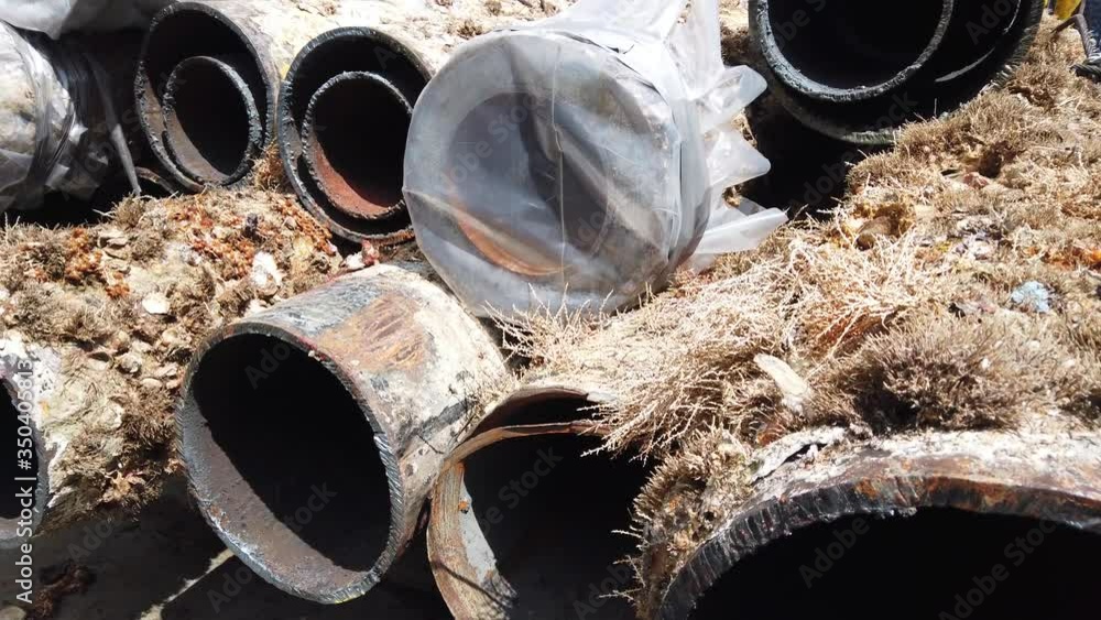 Old multi string casing conductors are cut with welding torch and laid ...