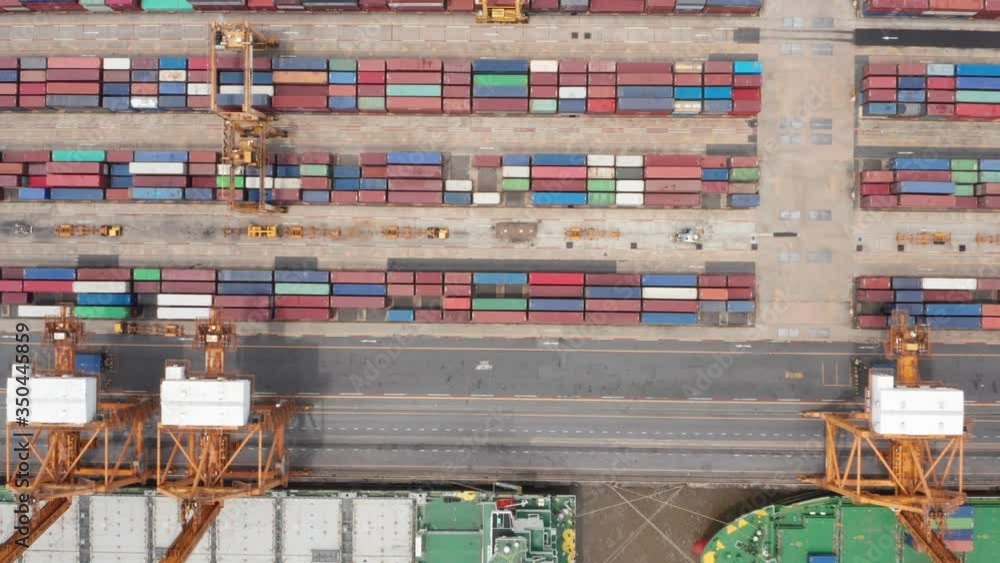 Aerial view of containers yard with ship vessels are loading and ...