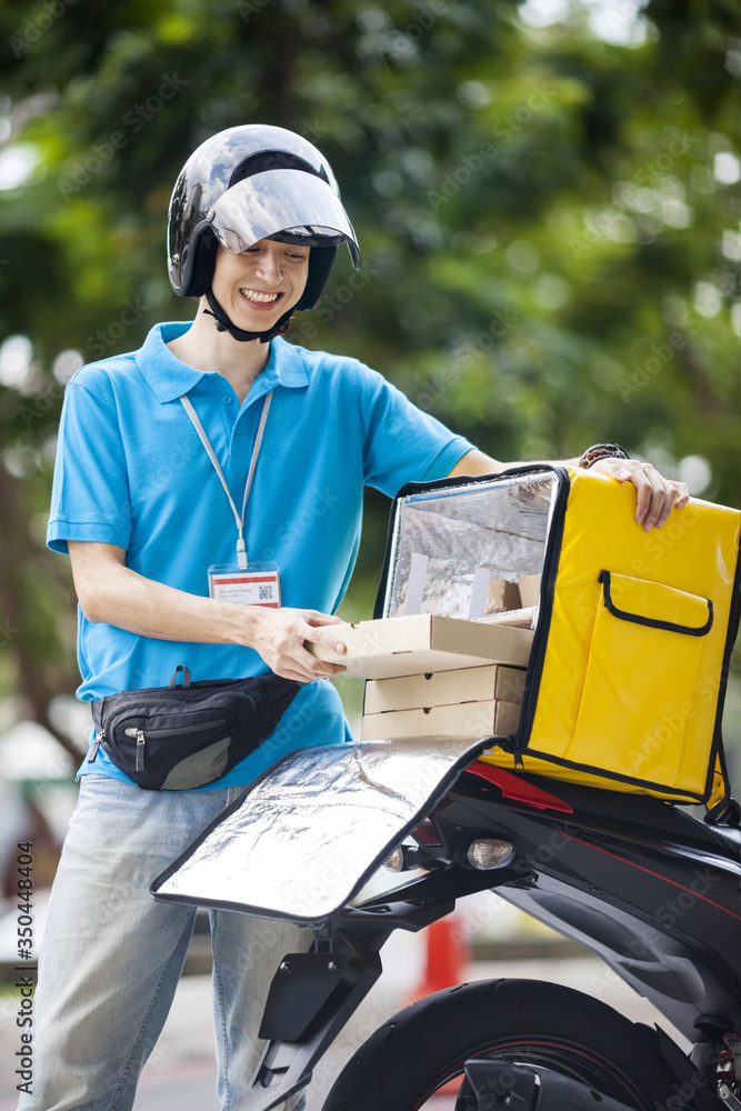 Food delivery man taking food from a bag Stock Photo | Adobe Stock