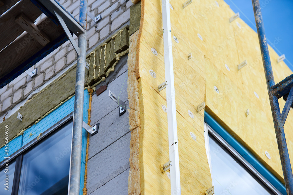office building under construction. Facing and insulation of walls ...