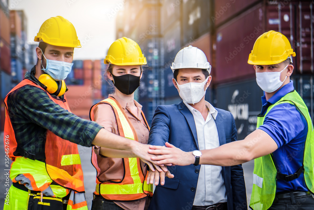 Engineer team people standing with their hands together at the ...