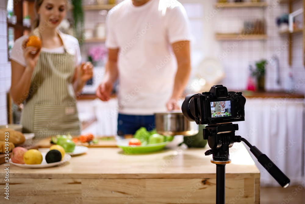 Beautiful young girl vlogger live cooking at kitchen for working from ...