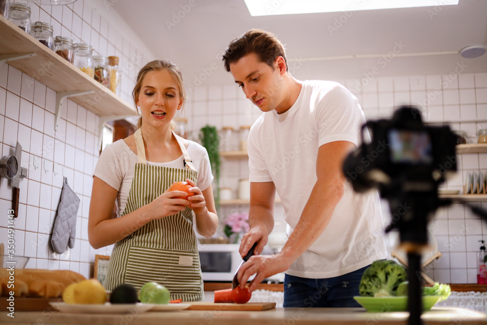 Beautiful young girl vlogger live cooking at kitchen for working from ...