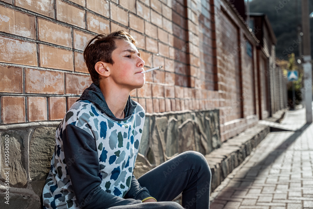 Smoking. Portrait of a teenage Boy Smoking a cigarette with a confident ...