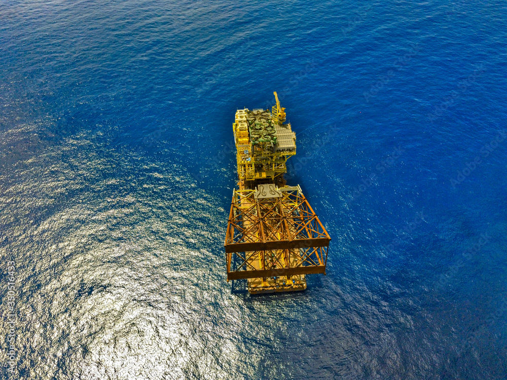 Barge towed by tug boat. Launch barge with topside and jacket loaded ...