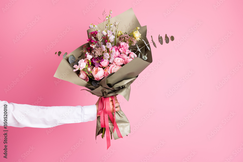 Photo of cropped man arm hold big bright decorated bunch giving ...