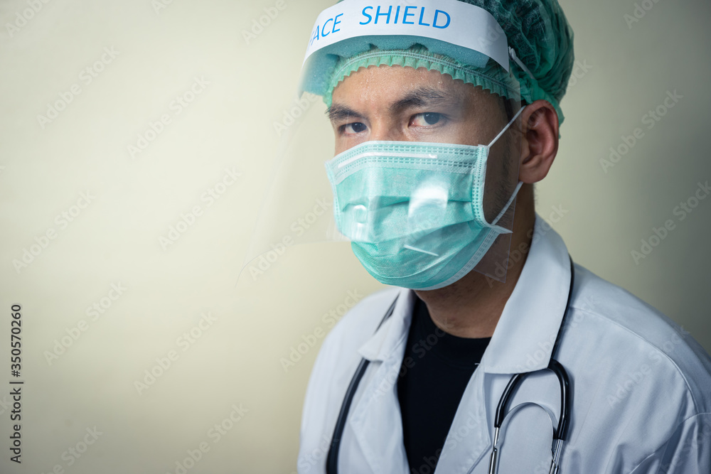 Closeup Asian male doctor wearing face shield and Personal Protective ...