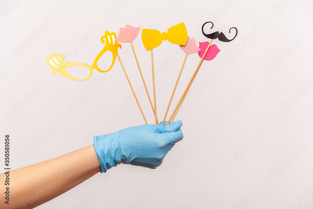 Profile side view closeup of human hand in blue surgical gloves holding ...