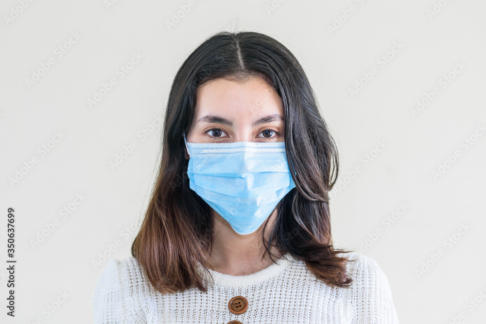 young beautiful asian woman showing how to wear a medical mask or ...