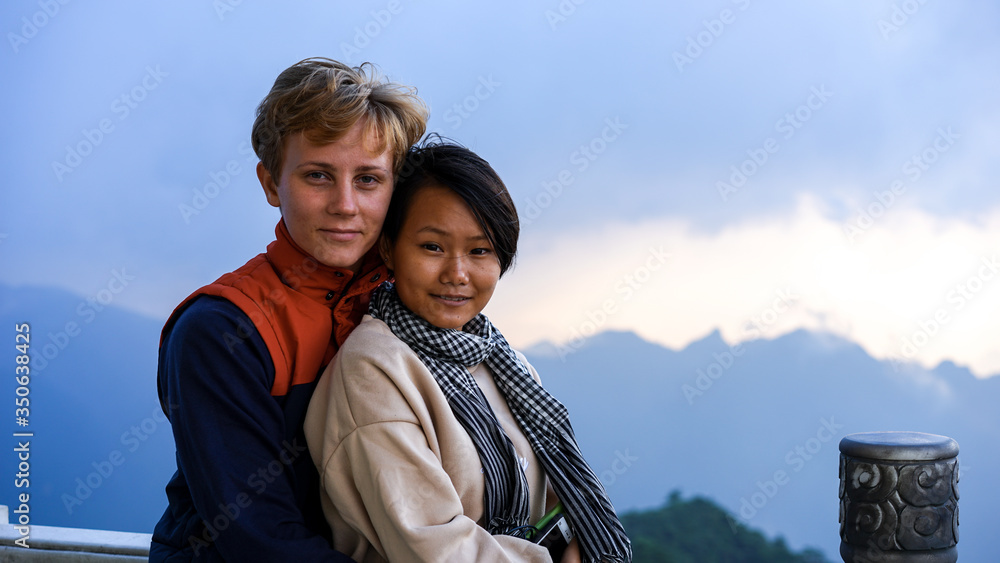 A young couple in love, Caucasian and Asian girls, international best ...