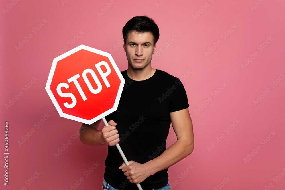No more bad habits. Close-up photo of a serious young man in a black t ...